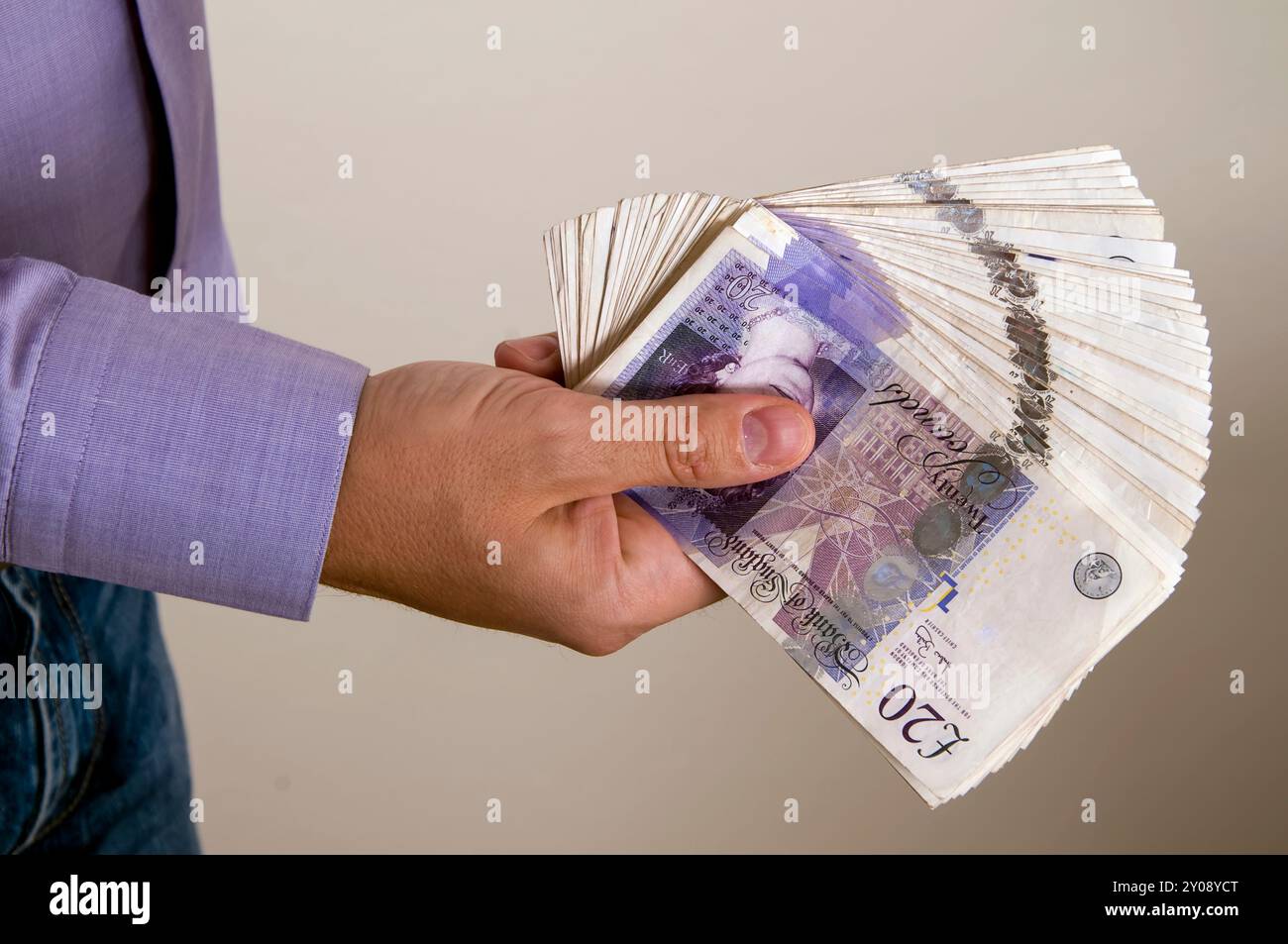 Businessman holding a lot of money with both hands hi-res stock ...