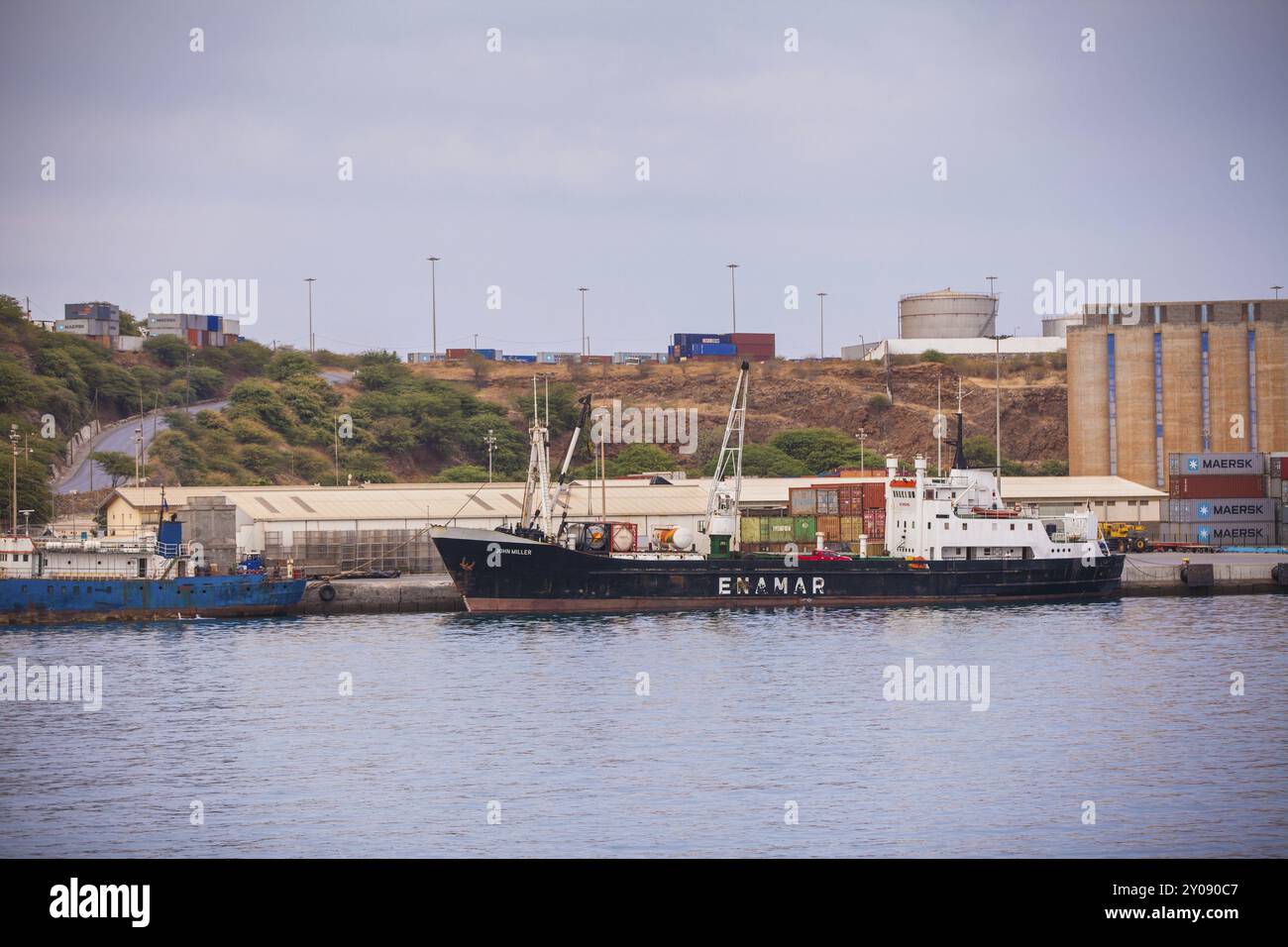 Black cargo ship at anchor in a harbour Stock Photo - Alamy