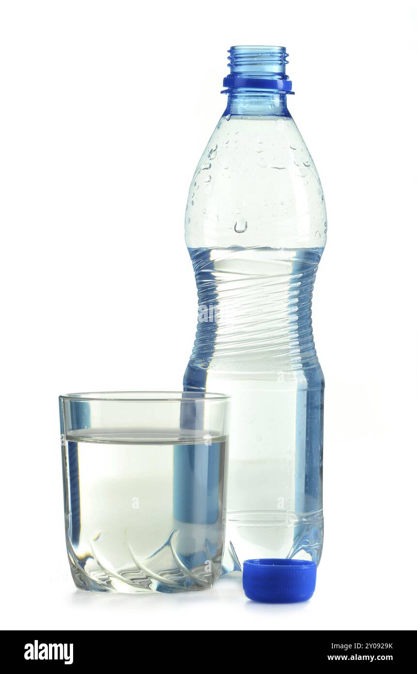 Polycarbonate plastic bottle of mineral water and glass of water ...