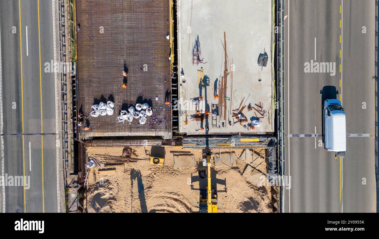 Aerial view of a construction site on a highway, featuring a large ...