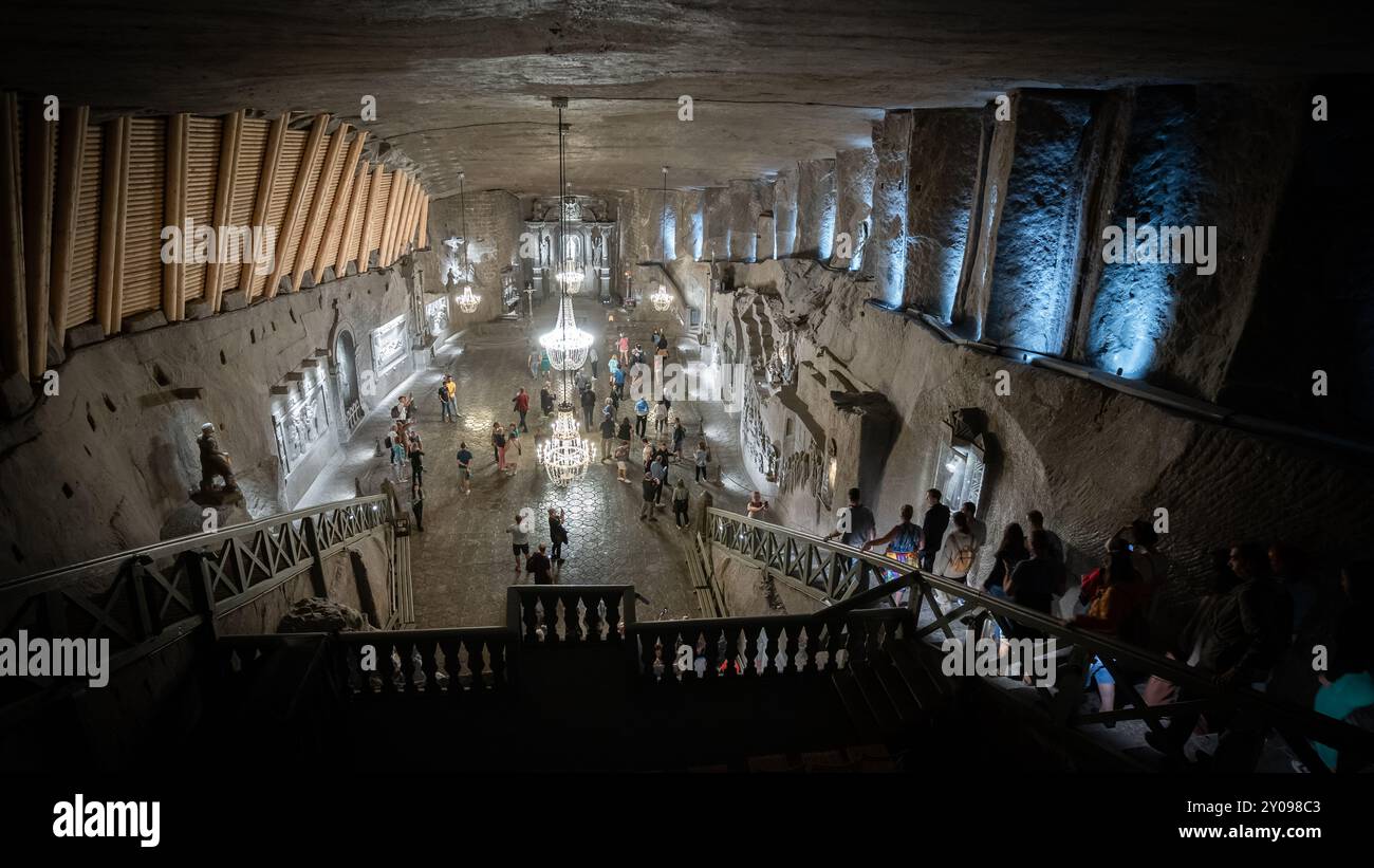 Huge subterrain hall with staircases and people located in big ...