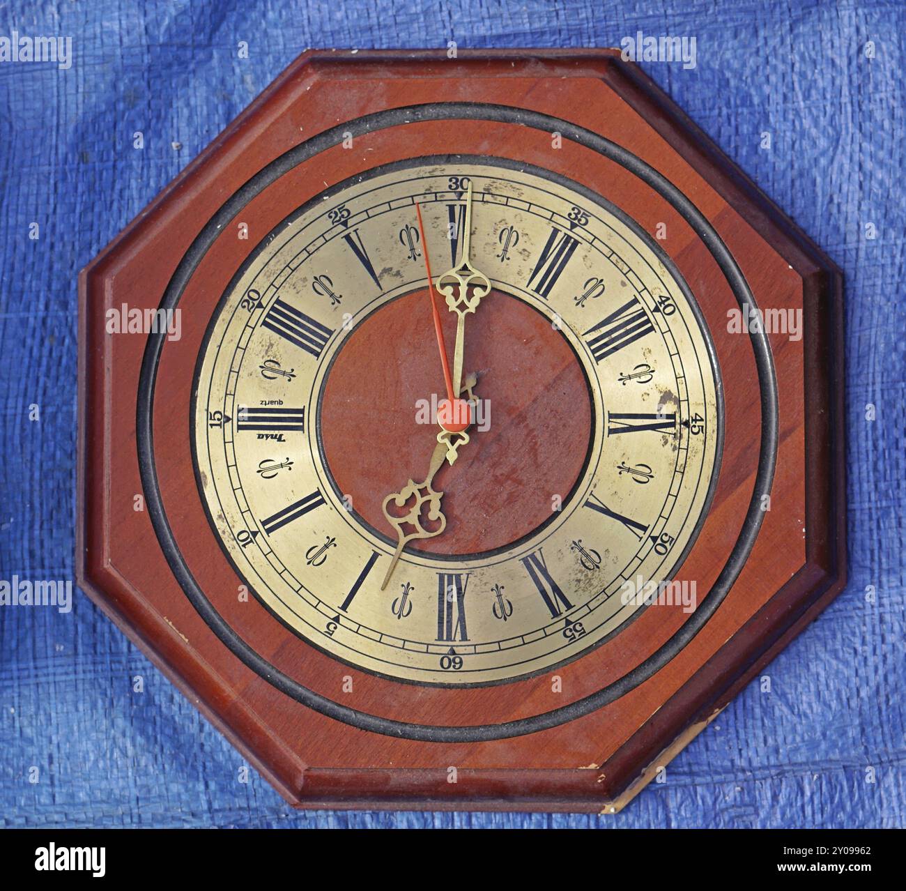 Octagonal wall clock with wood and brass Stock Photo - Alamy