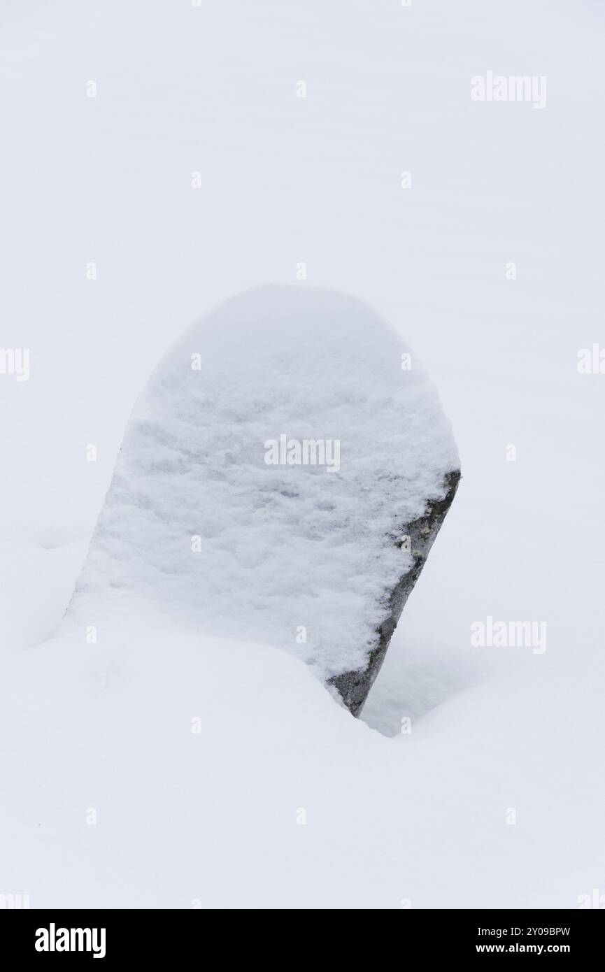 A snow covered tombstone in an ancient Swedish churchyard Stock Photo ...
