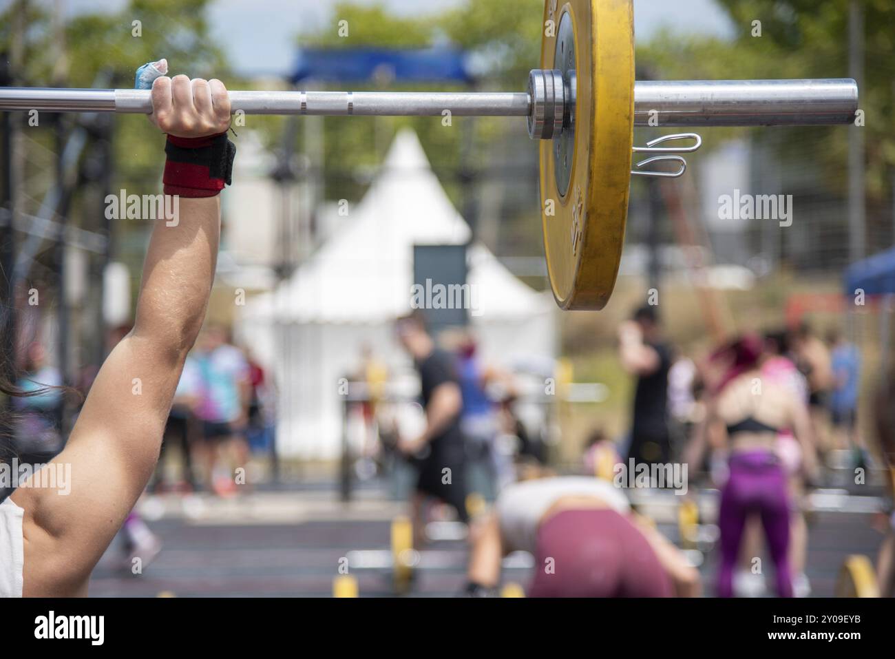 Scene of an outdoor weightlifting competition, with an athlete lifting ...