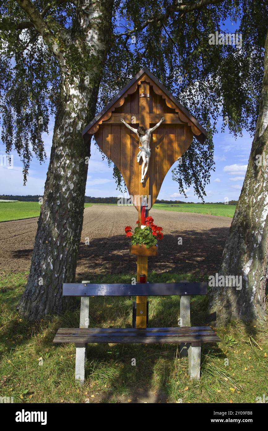 Bench and field cross under trees Stock Photo - Alamy
