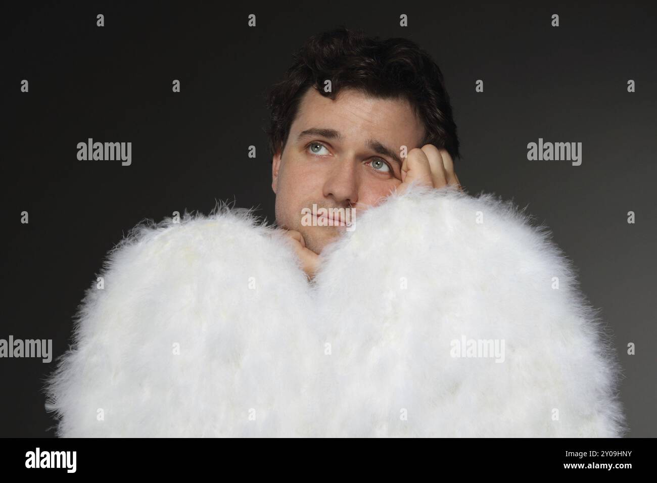 Mr. Angel with white wings. Creepy character portrait Stock Photo - Alamy