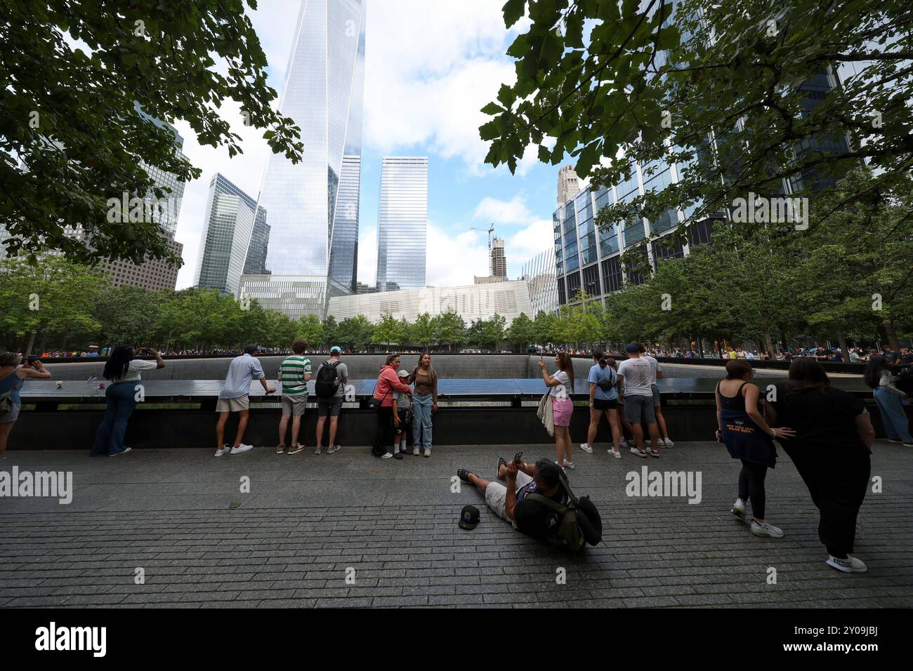 Tourists visit one of the two reflecting pools at the National ...