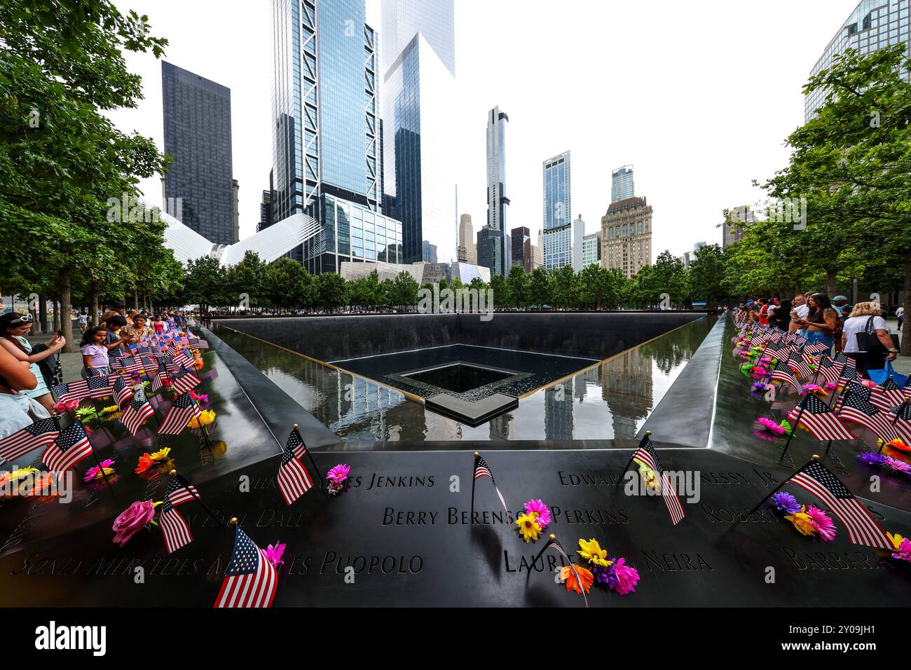 Tourists visit one of the two reflecting pools at the National ...