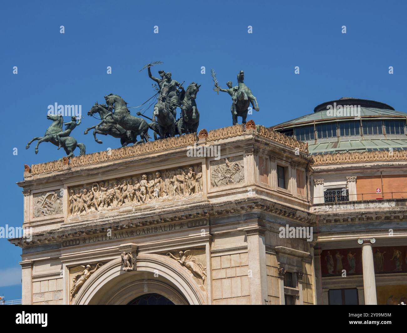 Monument with bronze statues on horses, surrounded by decorations and ...