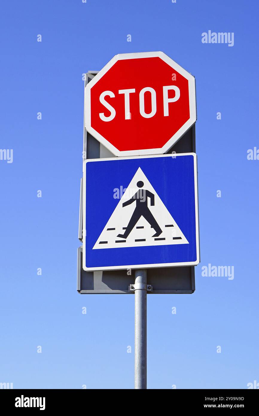 Stop sign and pedestrian crossing at traffic pole Stock Photo - Alamy