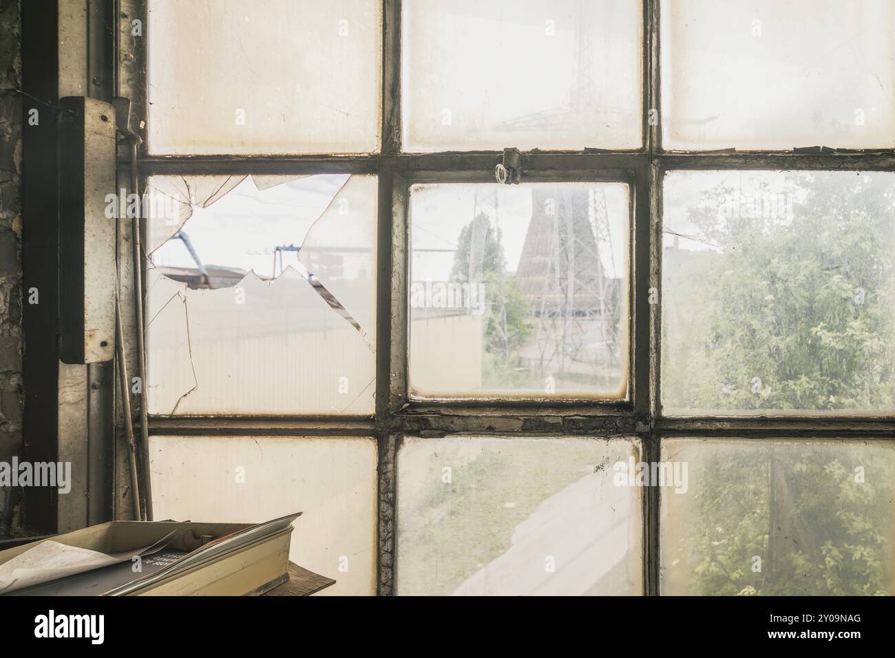 Old, broken window in a dilapidated industrial building, view of the ...