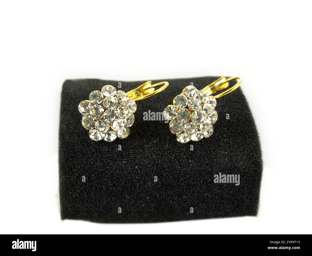 Diamond earrings on black sponge, isolated towards white background ...