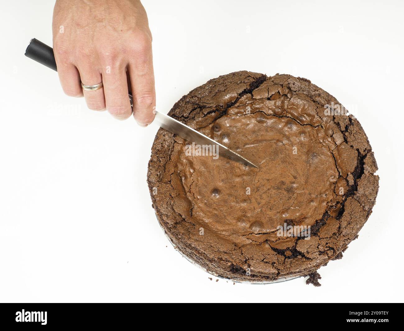 Fresh made chocolated cake being cut with a knife Stock Photo - Alamy