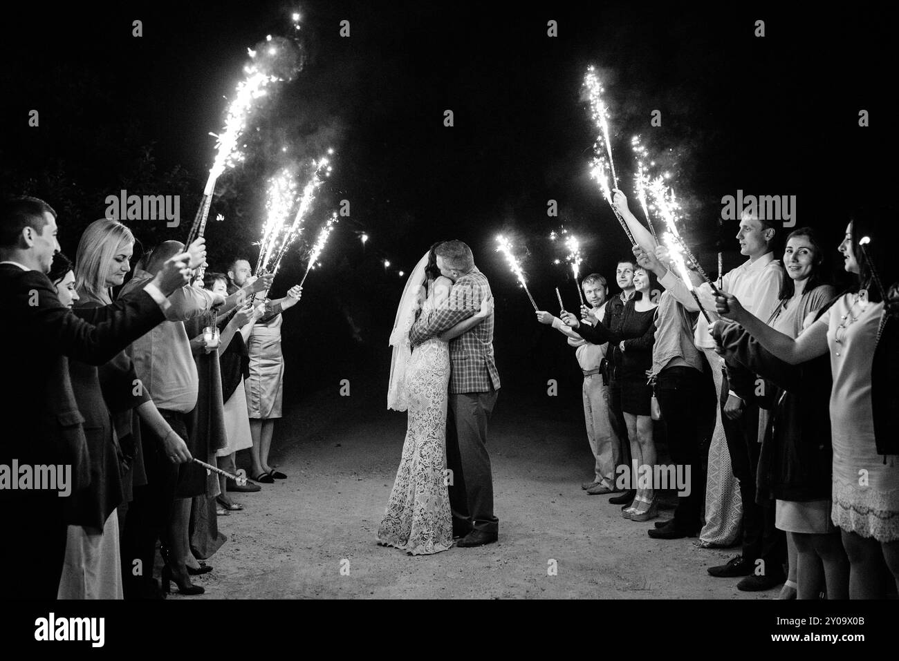 cold fire from cake candles and fireworks in the hands of people around ...