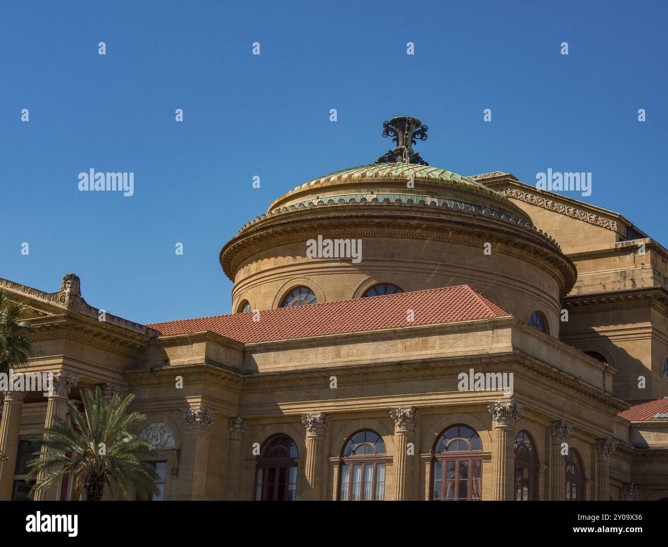 Historic theatre with classical architecture and dome under a clear ...