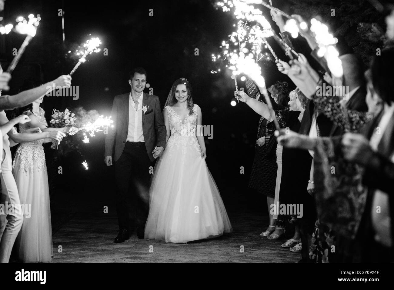 cold fire from cake candles and fireworks in the hands of people around ...