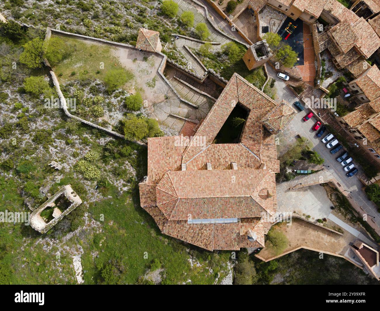 An aerial view of a historic fortress with tiled roofs and surrounding ...