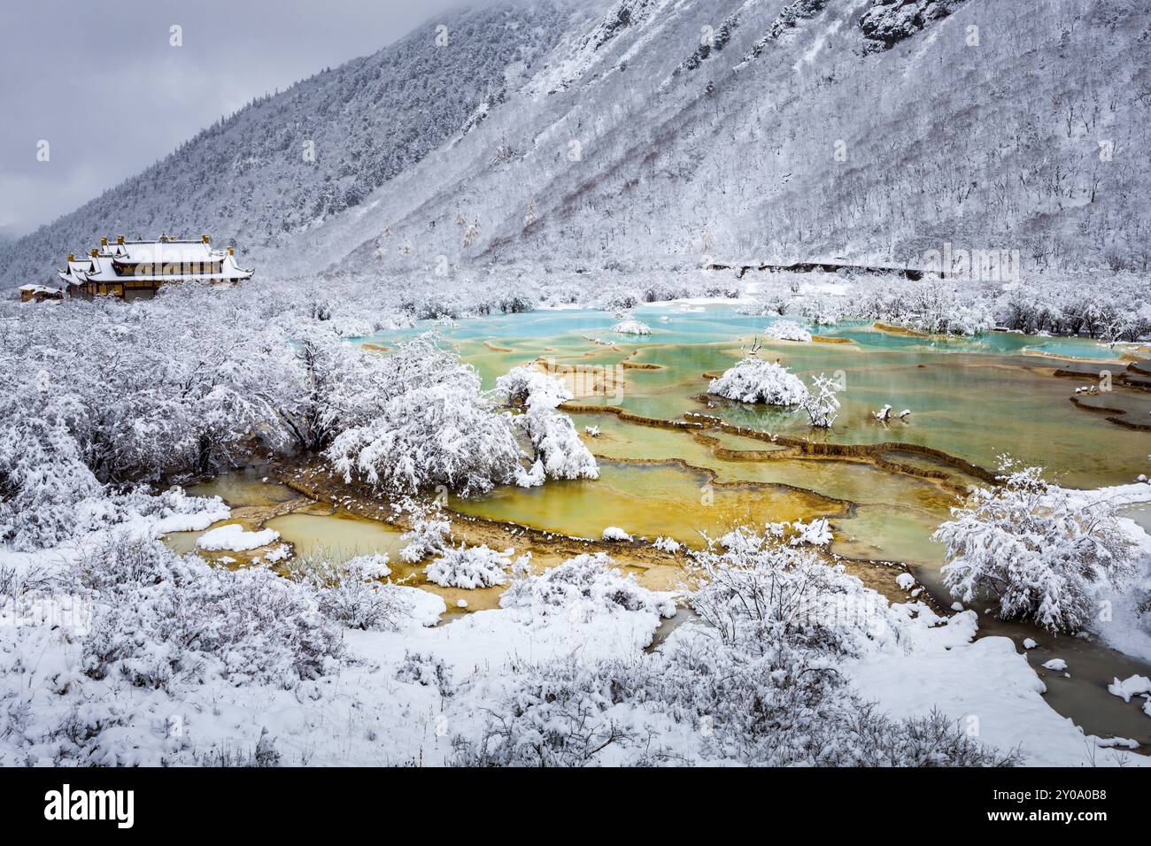 View of icy Colored Lake and Tibetan Temple in Huanglong, Sichuan ...