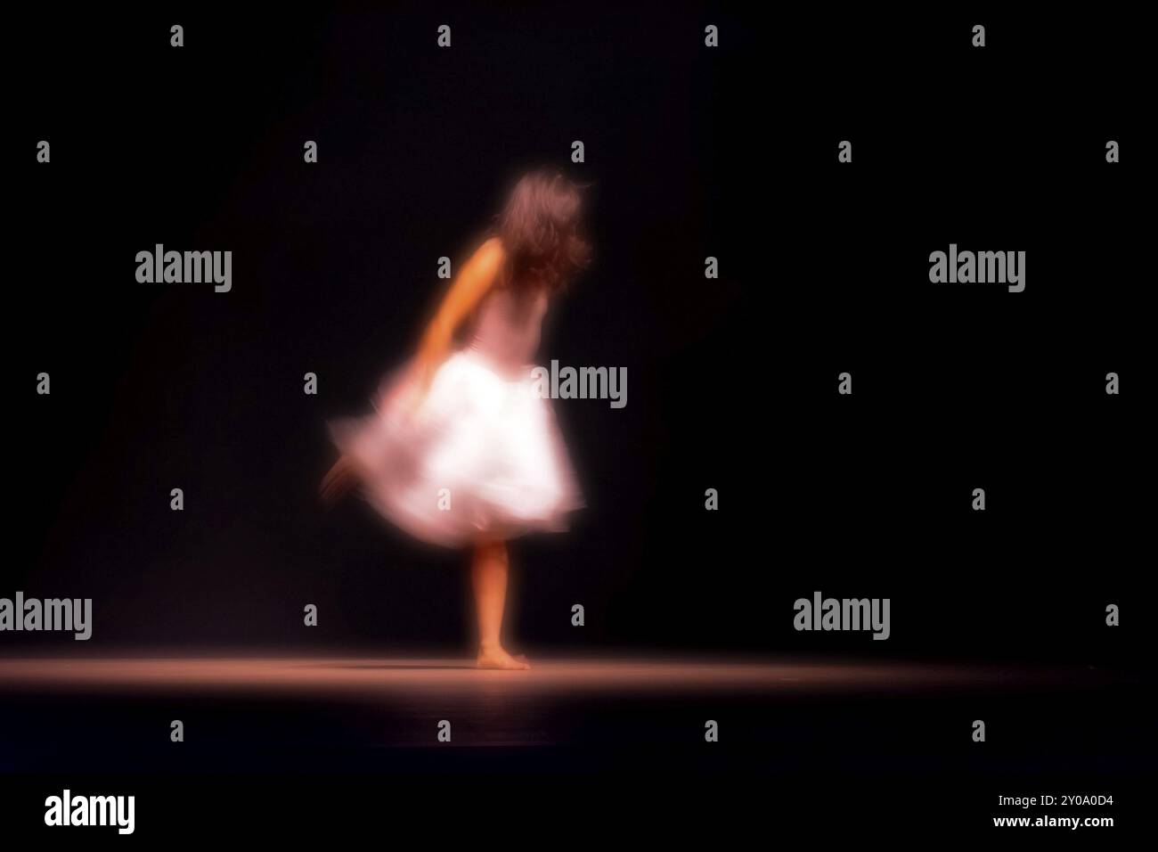 Young dancer with motion blurred during presentation of modern dance ...