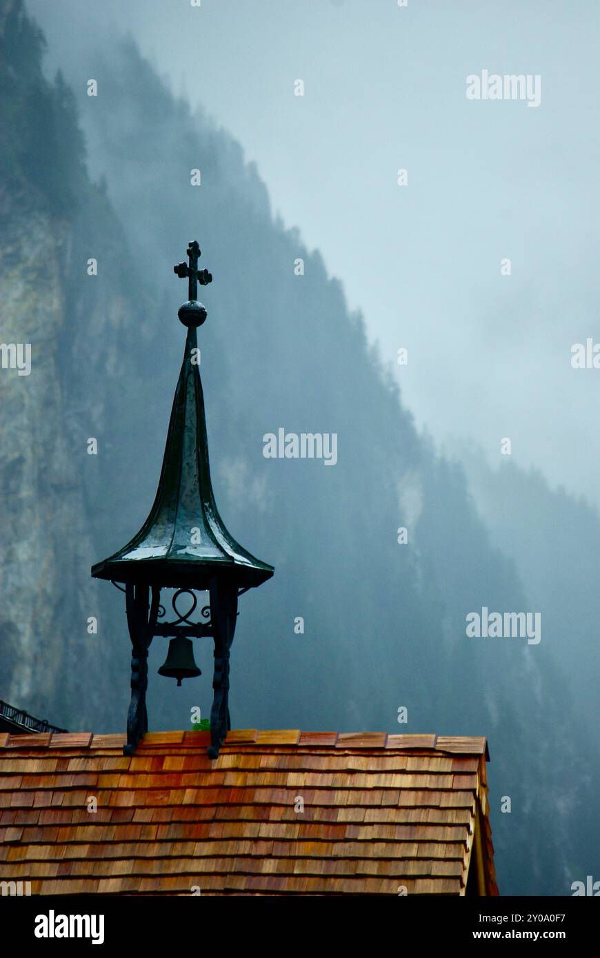 Mountain landscape with a Catholic chapel with a belfry on a rainy day ...