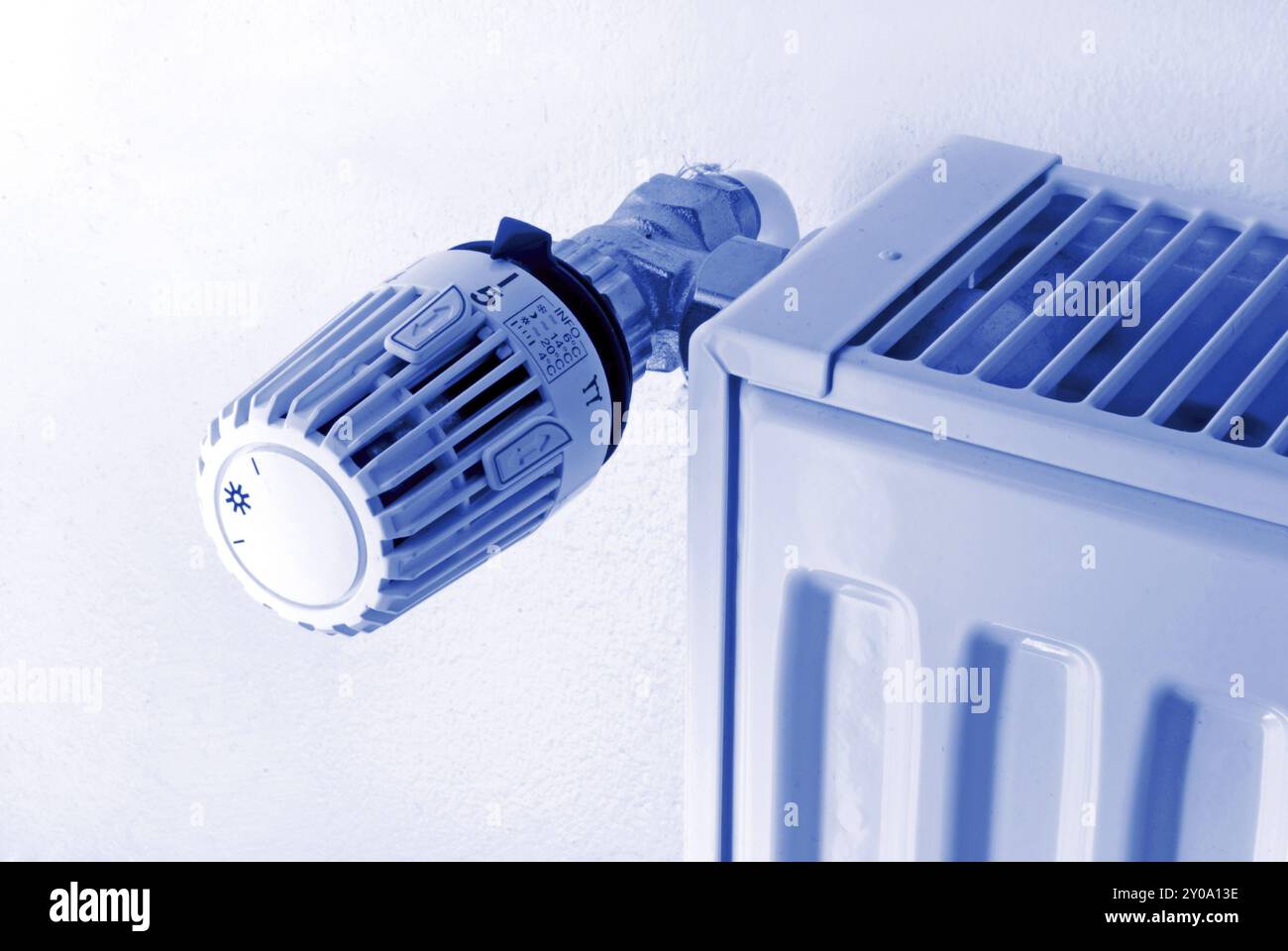 Radiator and thermostat in blue light effect Stock Photo - Alamy