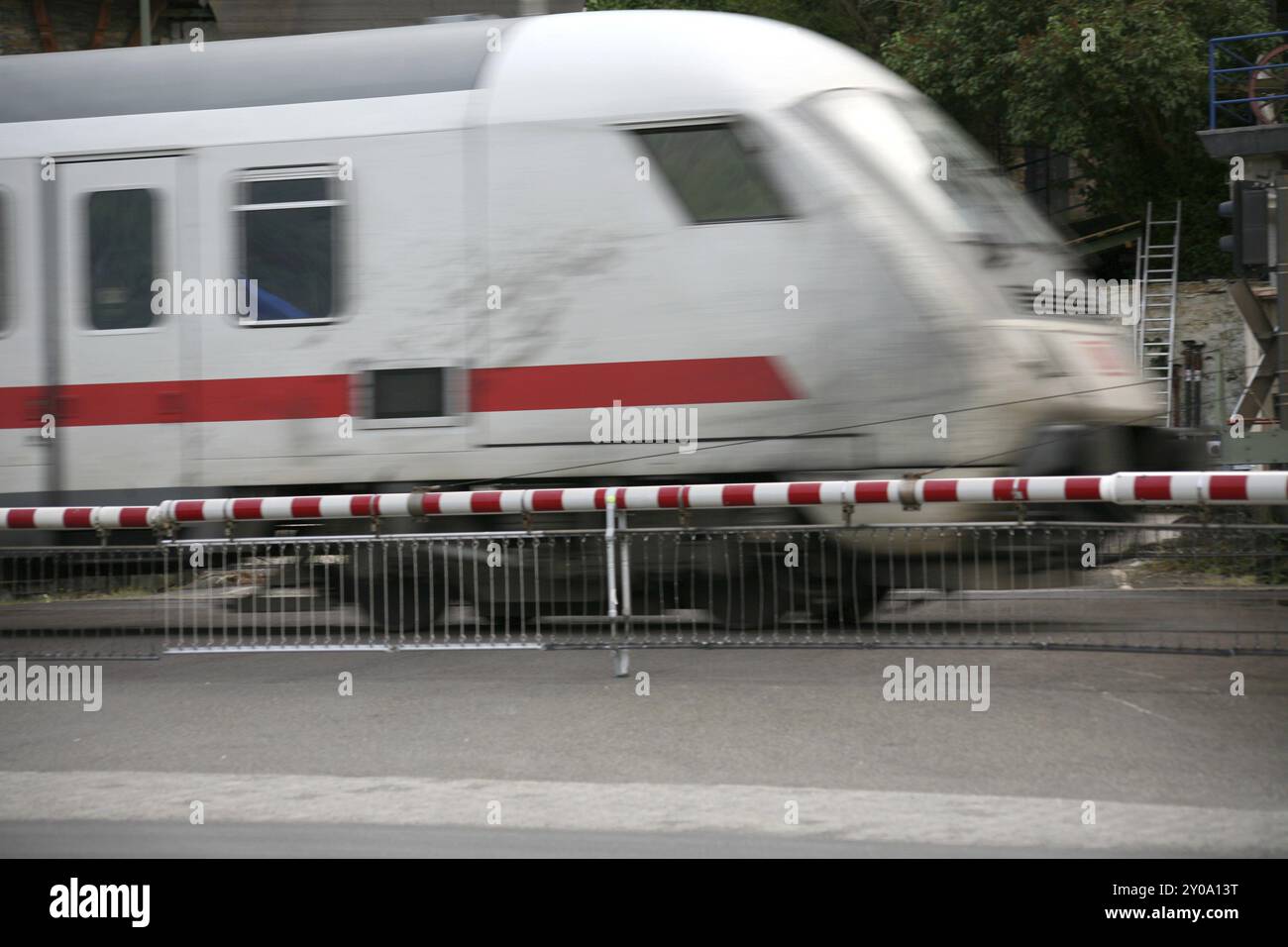 Rushing train with barrier Stock Photo - Alamy