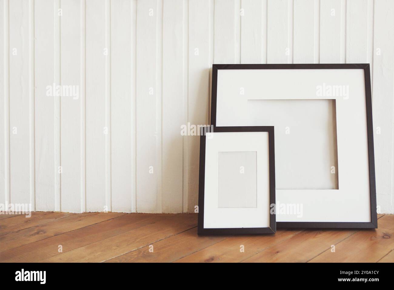 Two posters on the wooden floor by the white wall with copy space Stock ...