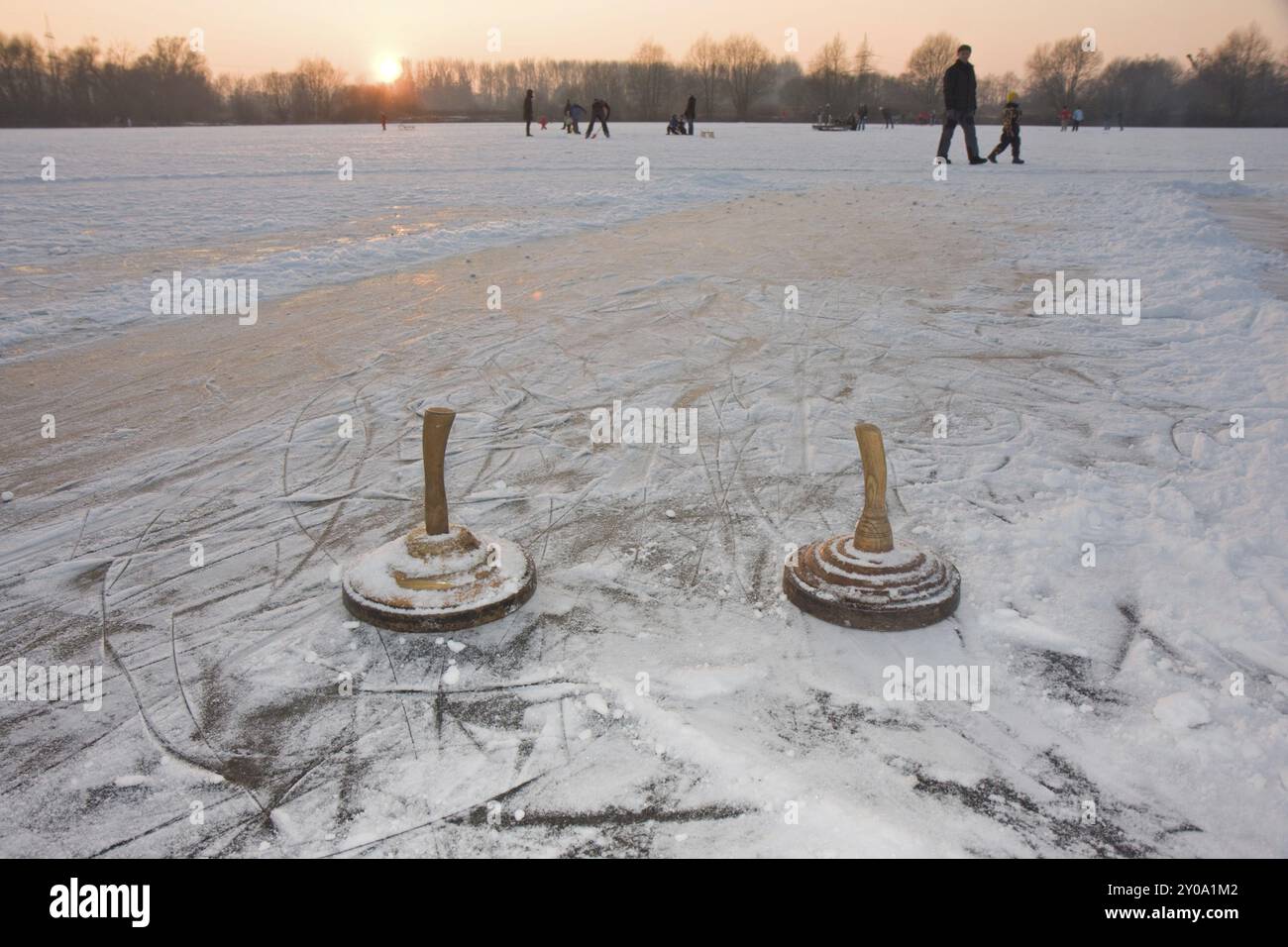 Ice sticks on a frozen lake at sunset Stock Photo - Alamy