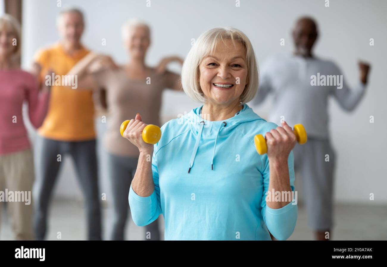 Seniors doing strength building fitness exercises with dumbbells Stock ...