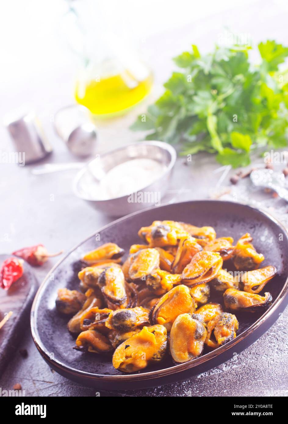 spicy stir fried mussel with slice onion and spice on plate Stock Photo ...