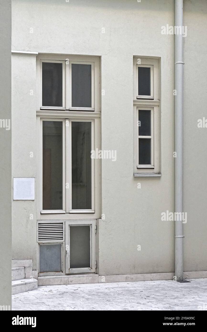 Long vertical windows at white building Stock Photo - Alamy