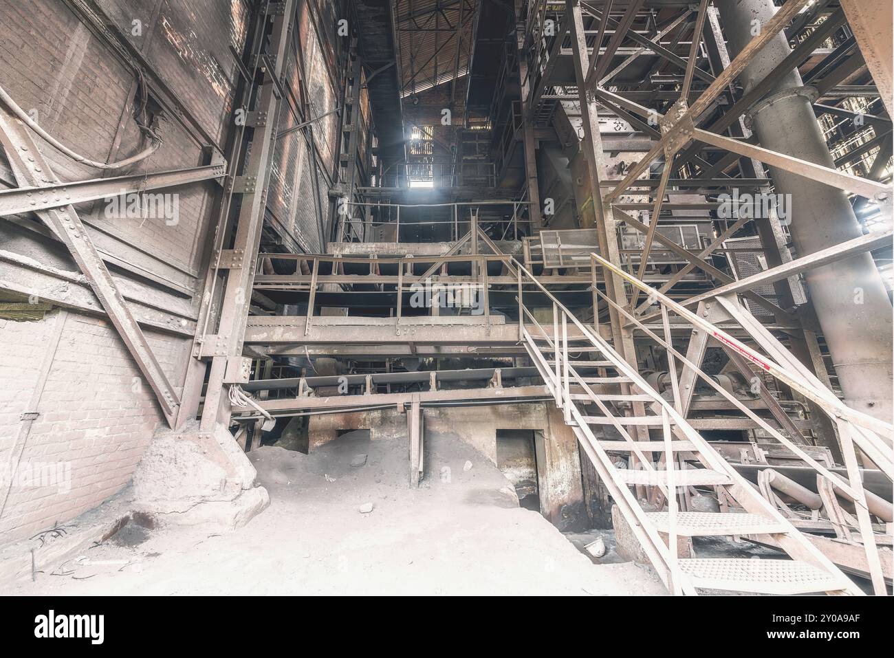 Abandoned and dusty industrial site with complex metal structures and ...