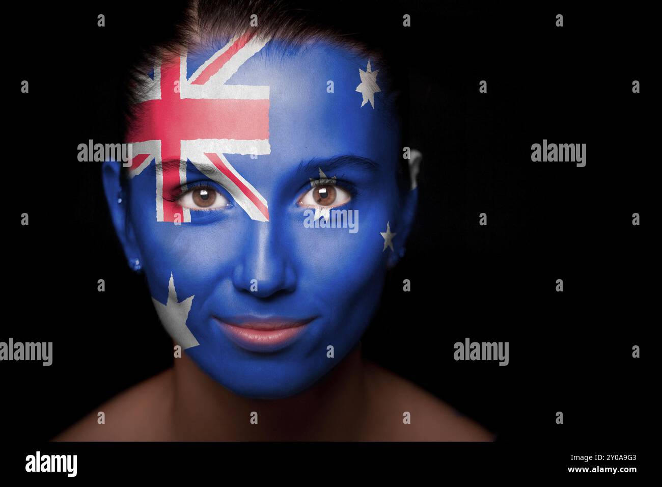 Portrait of a woman with the flag of the Australia painted on her face ...