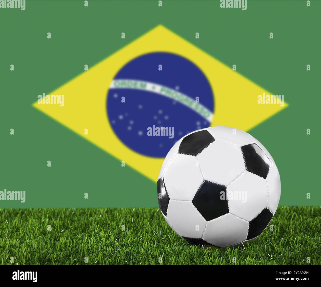 The Brazilian flag and soccer ball on the green grass Stock Photo - Alamy