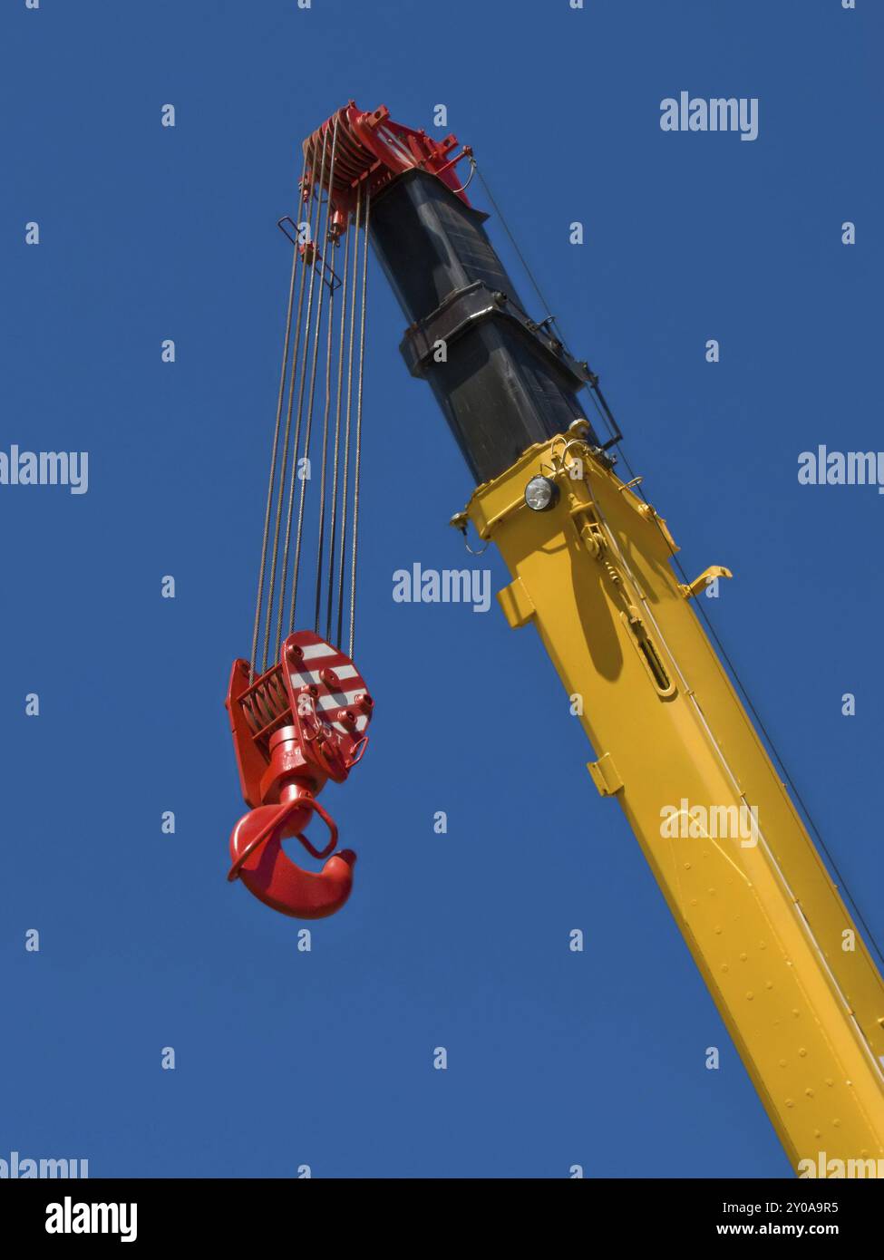 Building crane boom with steel hook Stock Photo - Alamy