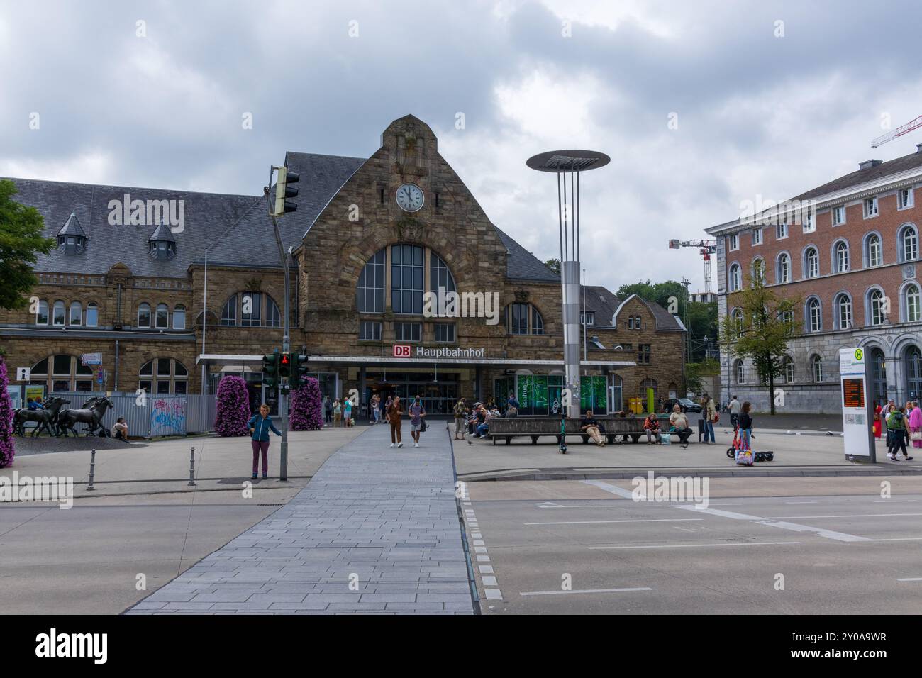 People standing at a crossing outside the main entrance to Aachen ...