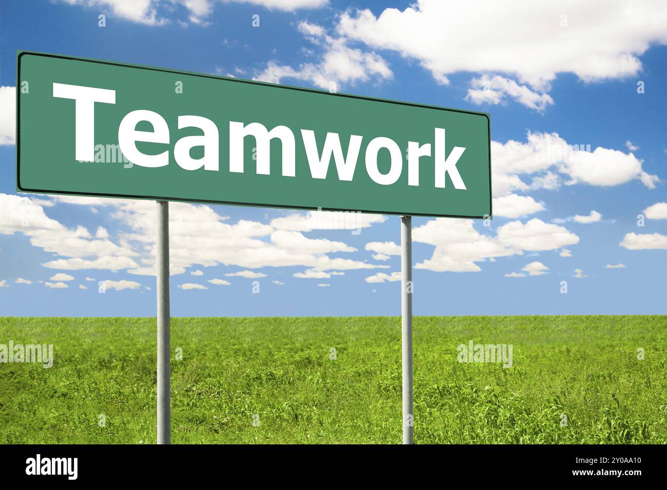 Teamwork Road Sign with blue sky and clouds Stock Photo - Alamy