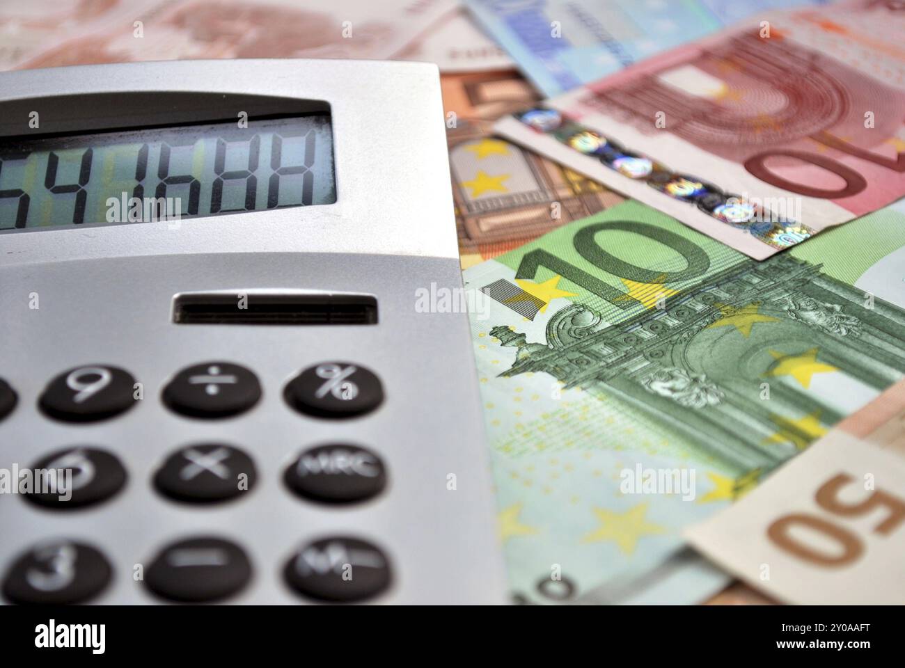Macro of a calculator over many euro banknotes Stock Photo - Alamy