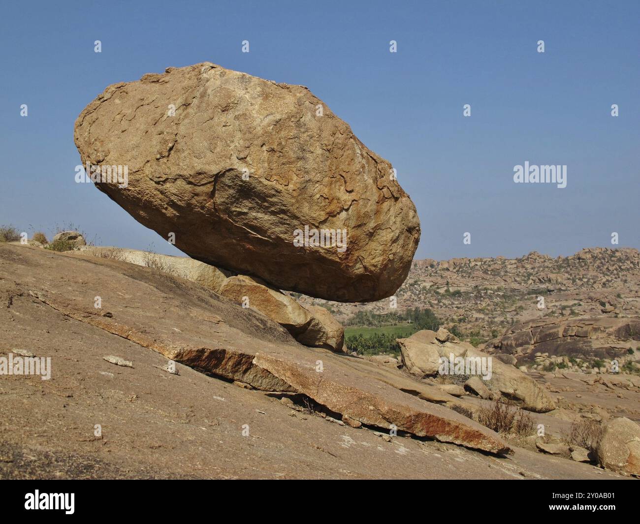 Big balancing granite boulder in Hampi, India. Giving a impression of ...