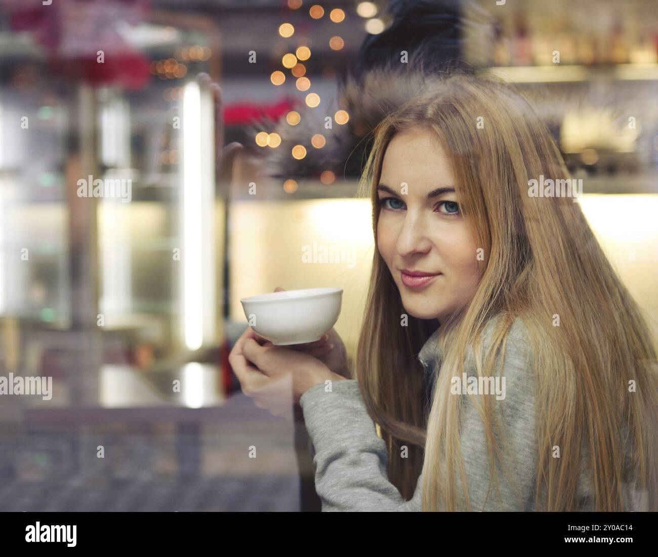 Young blond woman smiles drinks hi-res stock photography and images - Alamy