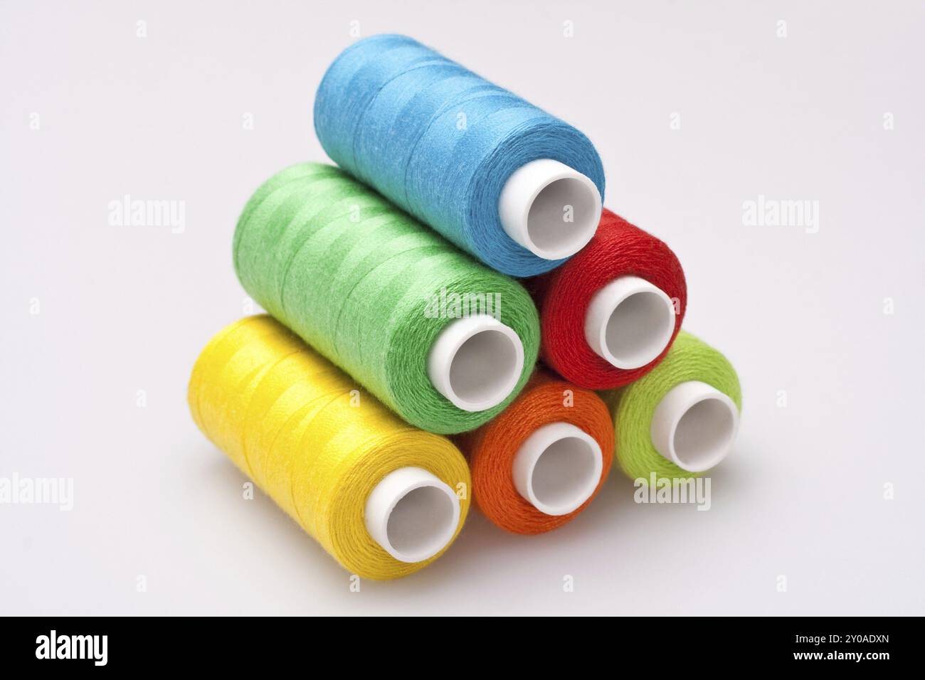 Multi-colored rainbow threads for sewing Stock Photo - Alamy
