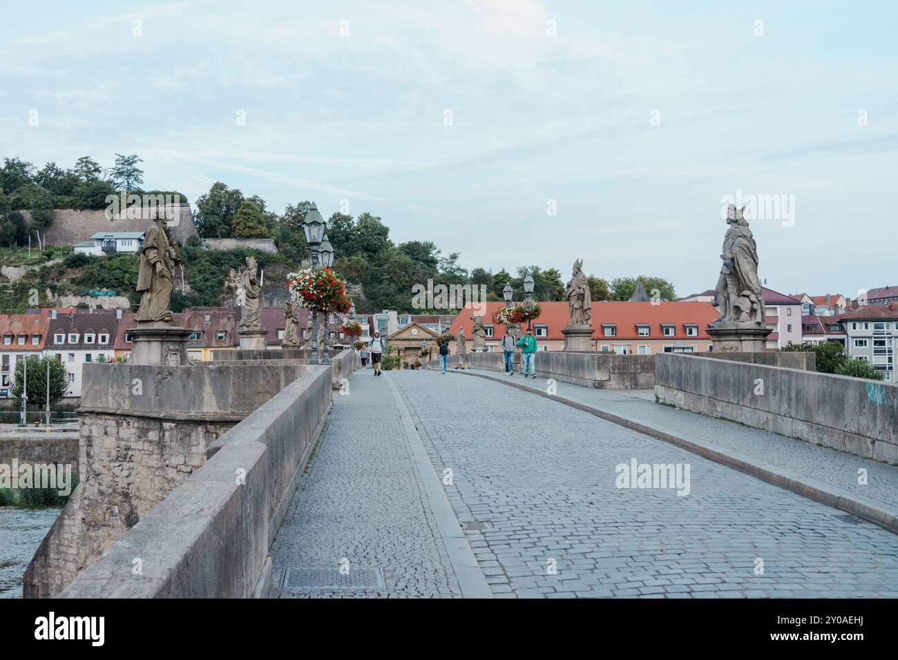 Pedestrians and stone statues on the Alte Mainbrücke - Old Main Bridge ...