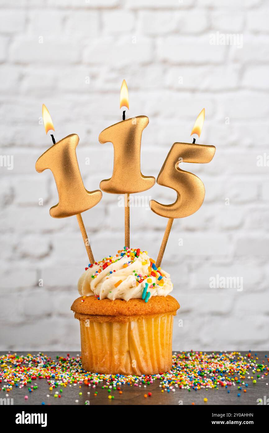 Golden birthday candle number 115 with cupcake - White block wall ...