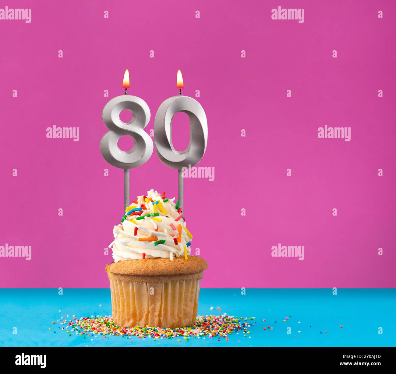 Lit birthday candle with the number 80 - Celebration card on violet and ...