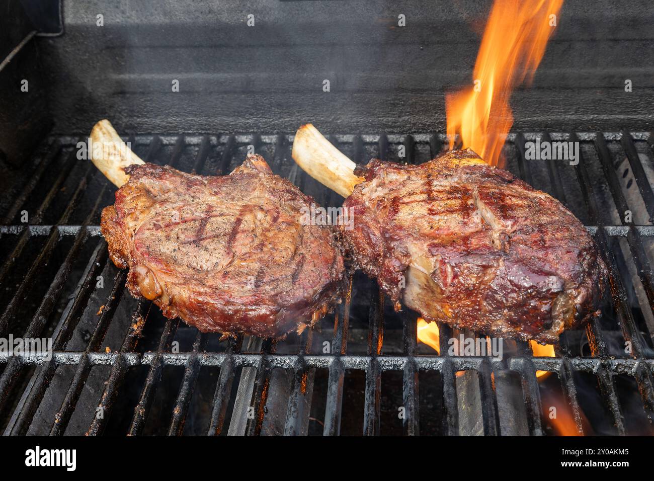 Tomahawk Steaks on the grill Stock Photo - Alamy
