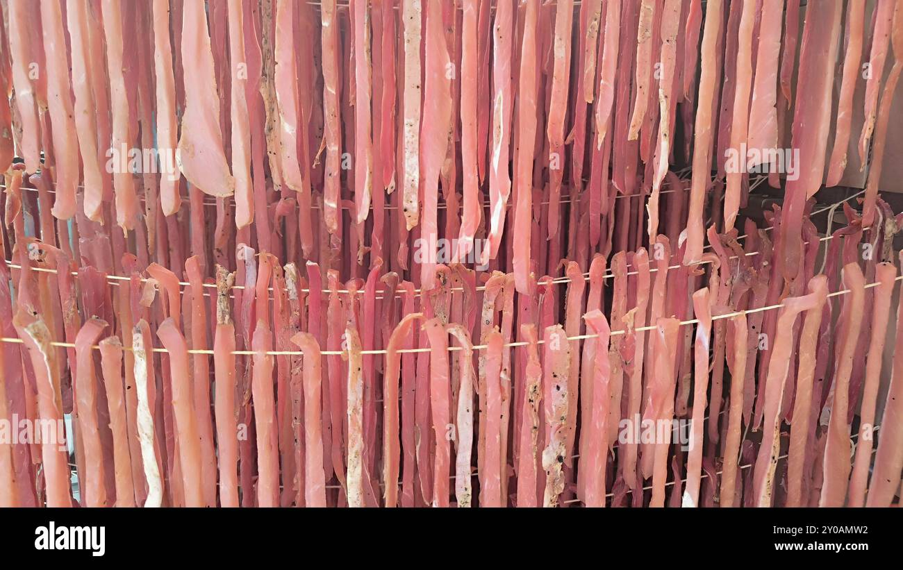 Traditional method of drying raw pork meat, a pork muscle delicacy, on ...