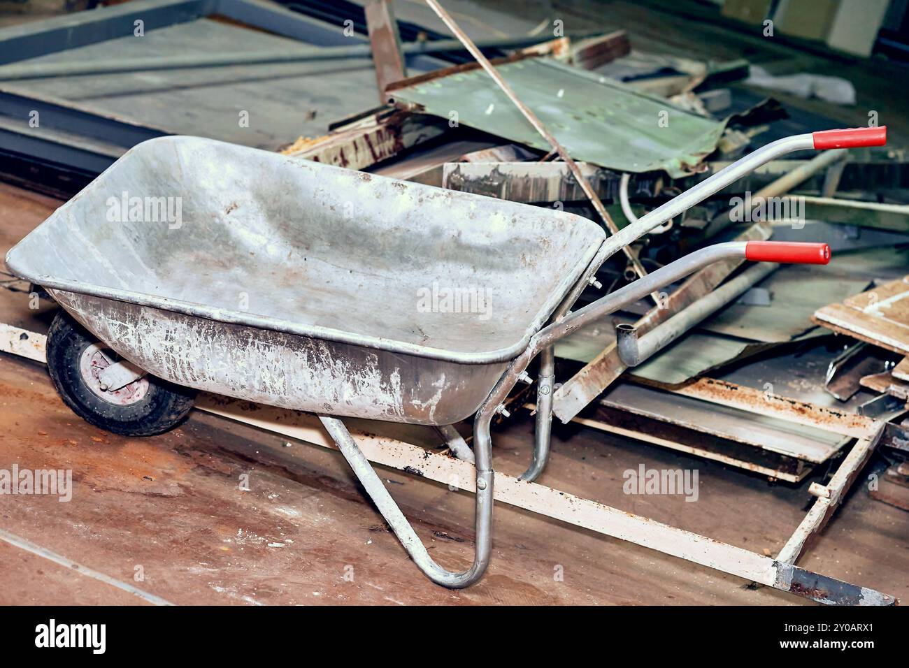 a small cart with a single wheel at the front and two supporting legs ...