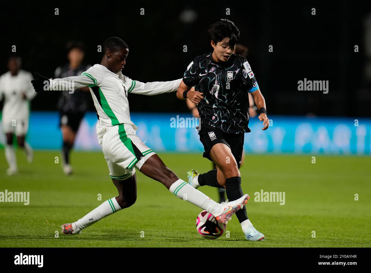 Nigeria's Shukurat Oladipo, left, attempts to tackle South Korea's Jeon ...