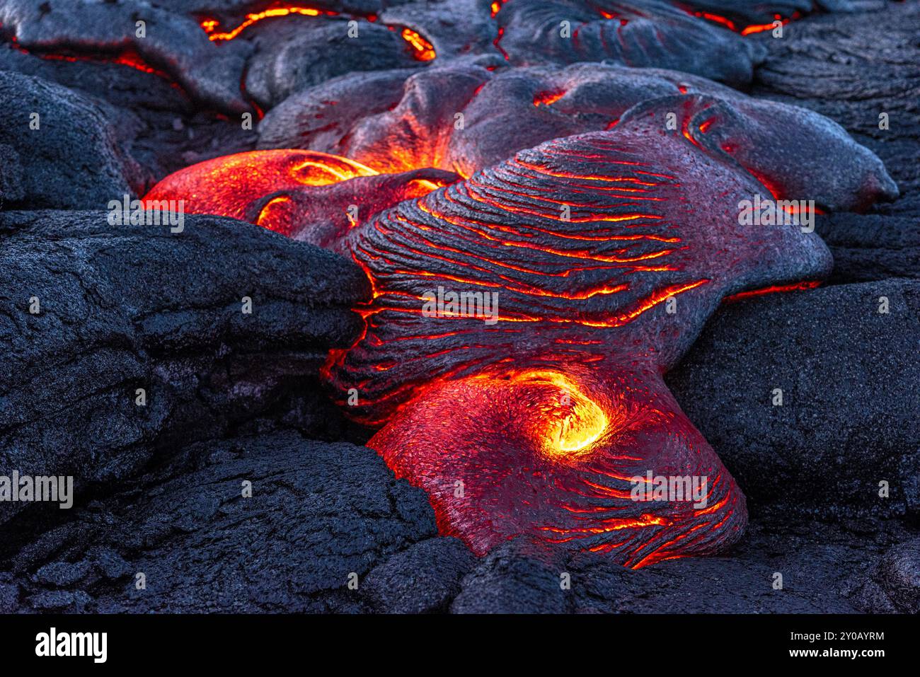 Hiking into the barren lava fields in Hawaii at night shows an active ...