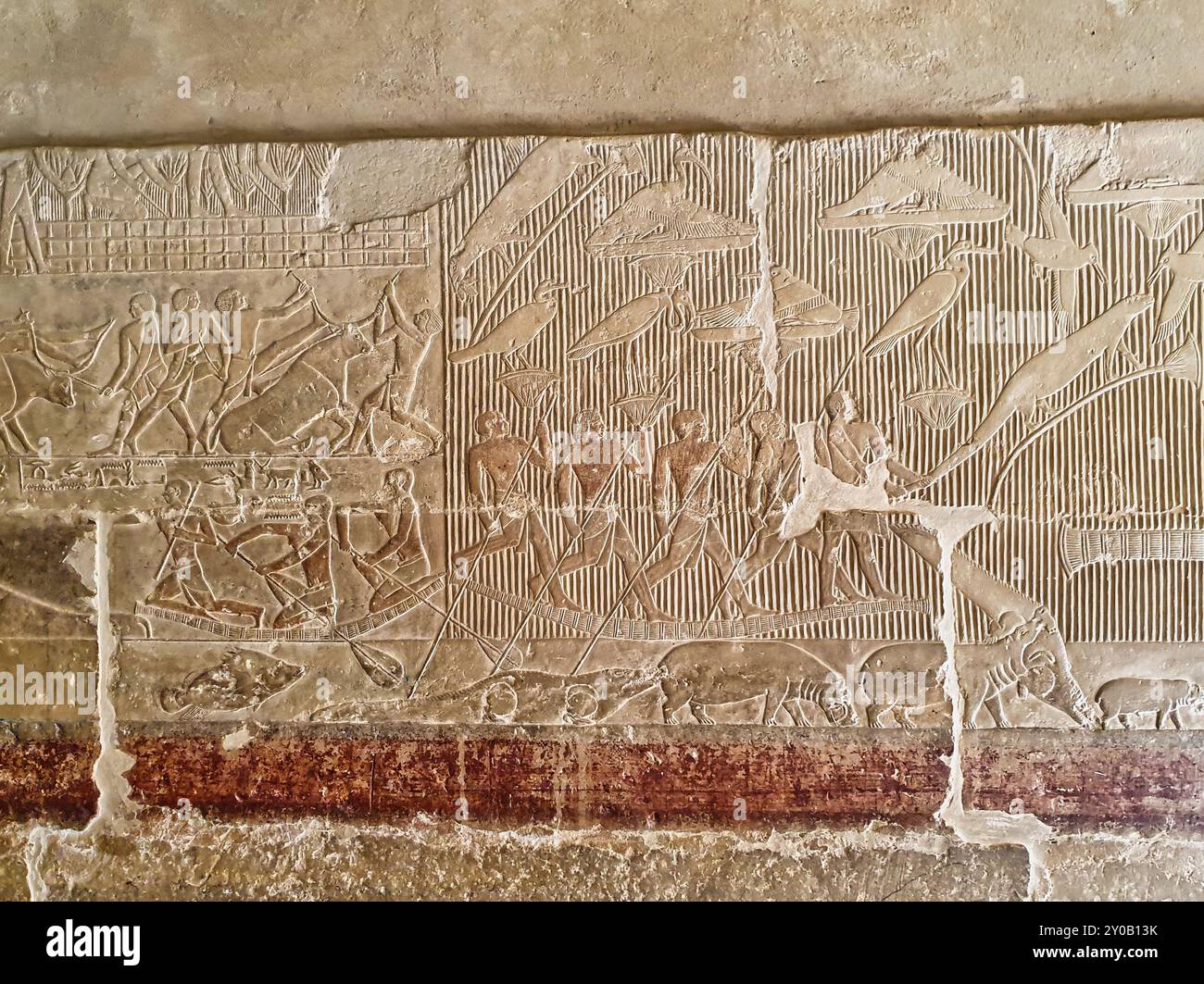 Intricate wall art showing hunting and cattle rearing scenes with ...